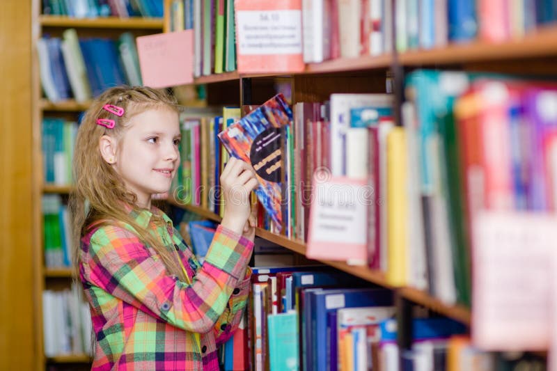 Young Girl Chooses a Book in the Library Stock Photo - Image of casual ...
