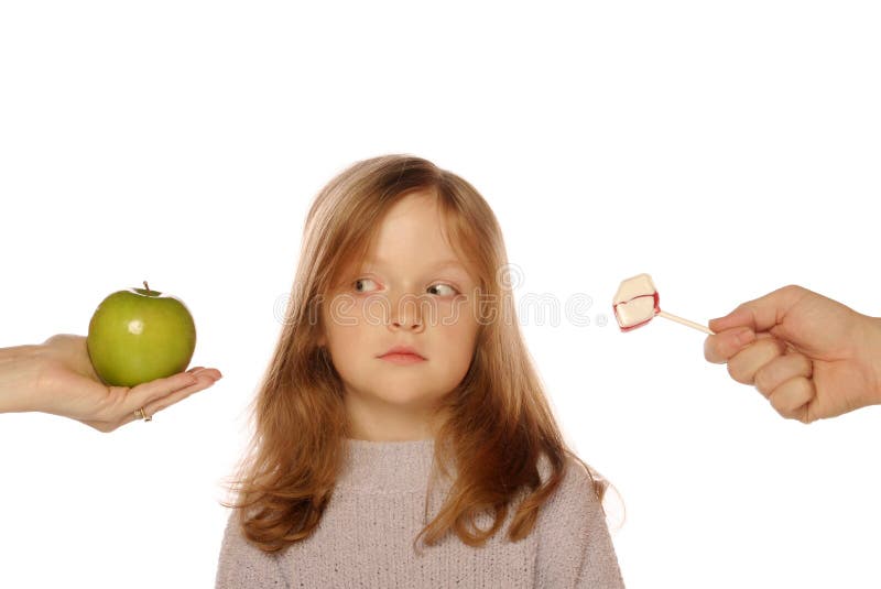 Young Girl Choosing between an Apple and Candy Stock Image - Image of ...