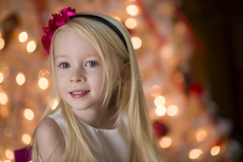 Young Girl by Christmas Tree Stock Photo - Image of wondering, blond ...