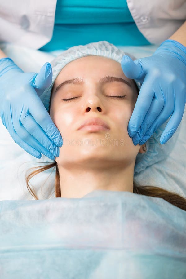 A Young Girl Is Cleaning The Skin Of Her Face At A Cosmetologist