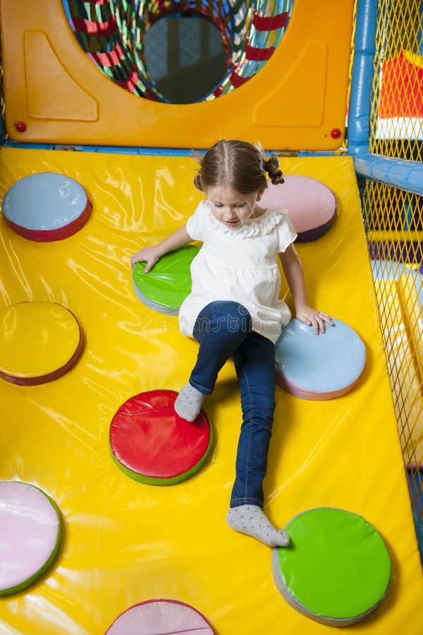 Young Girl Climbing Down Ramp in Soft Play Centre Stock Photo - Image ...