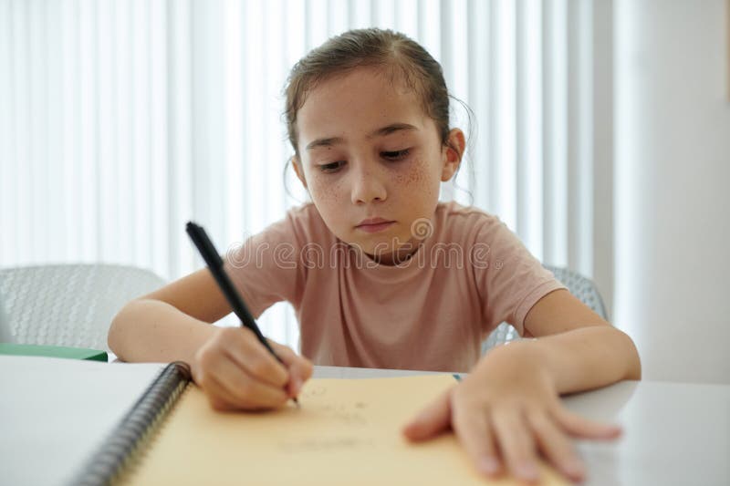 Young Girl Concentrating on Drawing in Notebook Stock Image - Image of ...