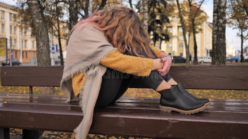 A Young Girl Crying on a Park Bench in the Fall. Stock Video - Video of ...