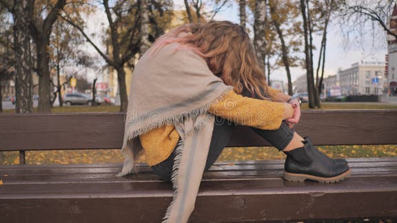 A Young Girl Crying on a Park Bench in the Fall. Stock Photo - Image of ...