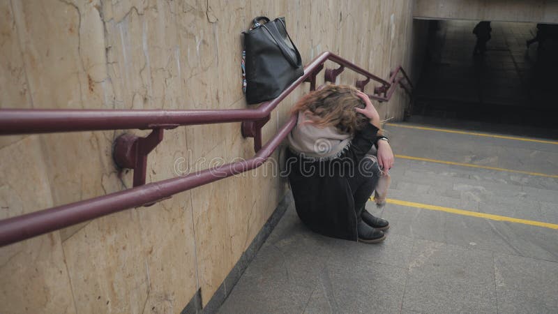 A Young Girl Crying by the Stairs in the Subway. Stock Image - Image of ...