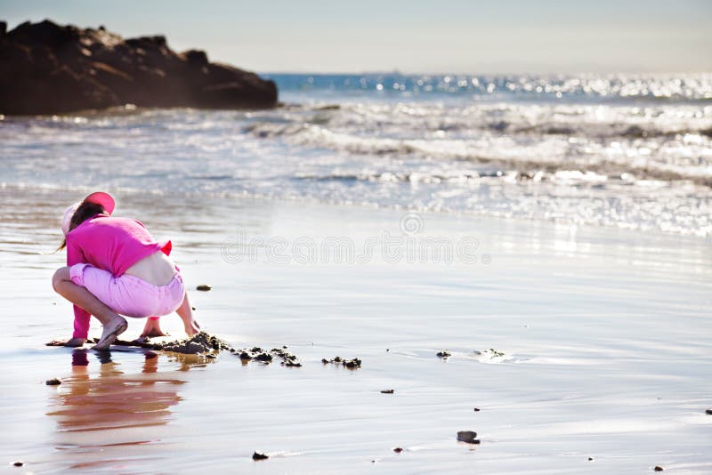 Young Girl Digging in the Sand Stock Photo - Image of coastline, ocean ...