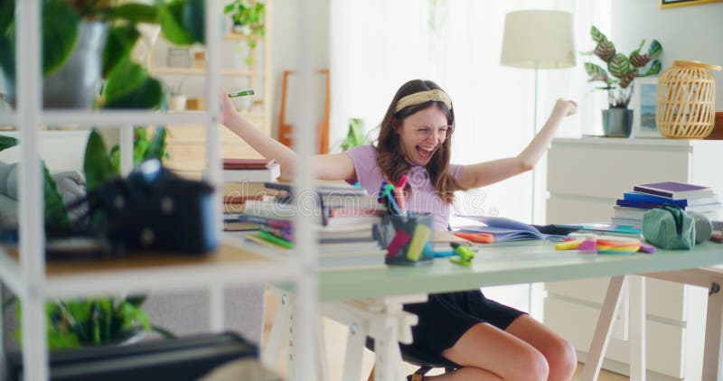 A Young Girl Does Her Math Homework and Uses a Calculator while ...