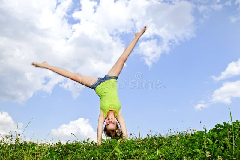 Young girl doing cartwheel stock image. Image of exercise - 11567017