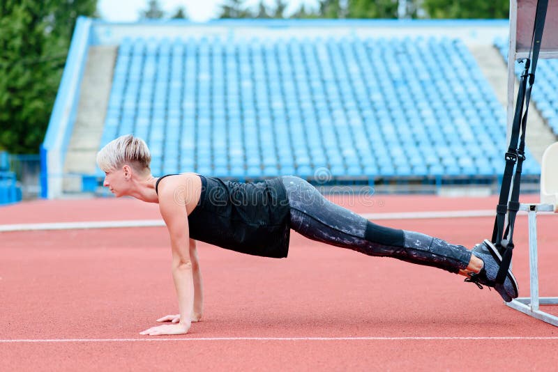 Young Girl Doing Exercises Outdoors Using Slings, TRX Loop Stock Photo ...