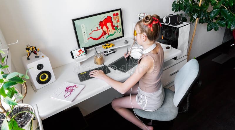 A Young Girl Draws on a PC Using a Graphics Tablet in Her Comfortable ...