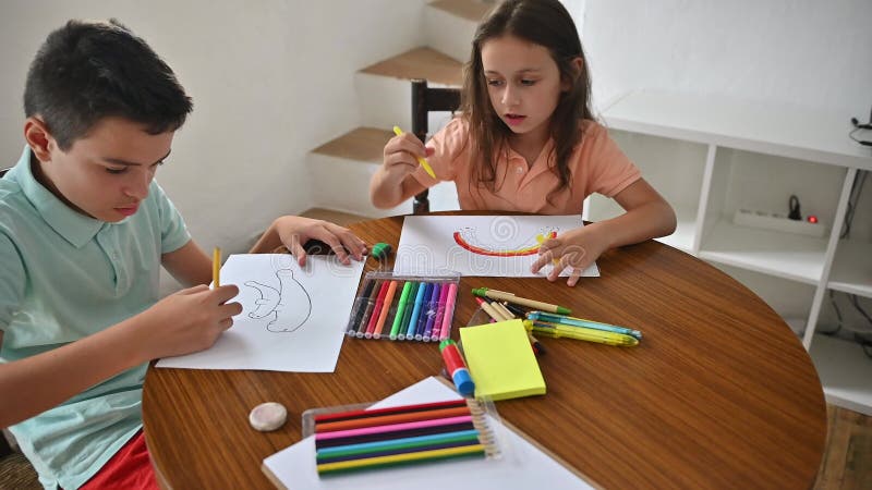 Young Girl Drawing a Colorful Rainbow with Markers at Home, Focusing on ...