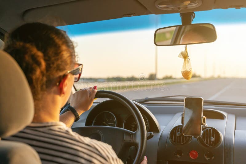 Young Girl Driving a Car while Driving, Rear View Stock Photo - Image ...