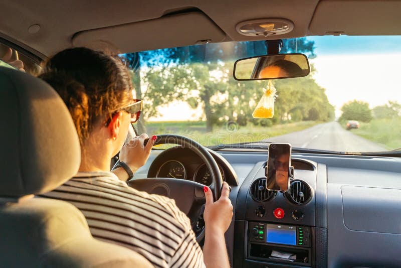 Young Girl Driving a Car while Driving, Rear View Stock Image - Image ...