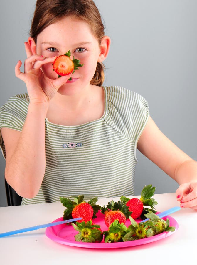 Young girl eating berries stock photo. Image of childhood - 7929190