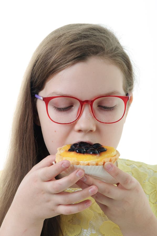 Young girl eating cake stock image. Image of isolated - 105395873