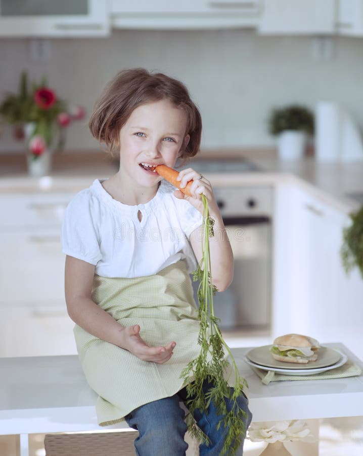 Girl eating carrot stock photo. Image of adult, yellow - 12183838