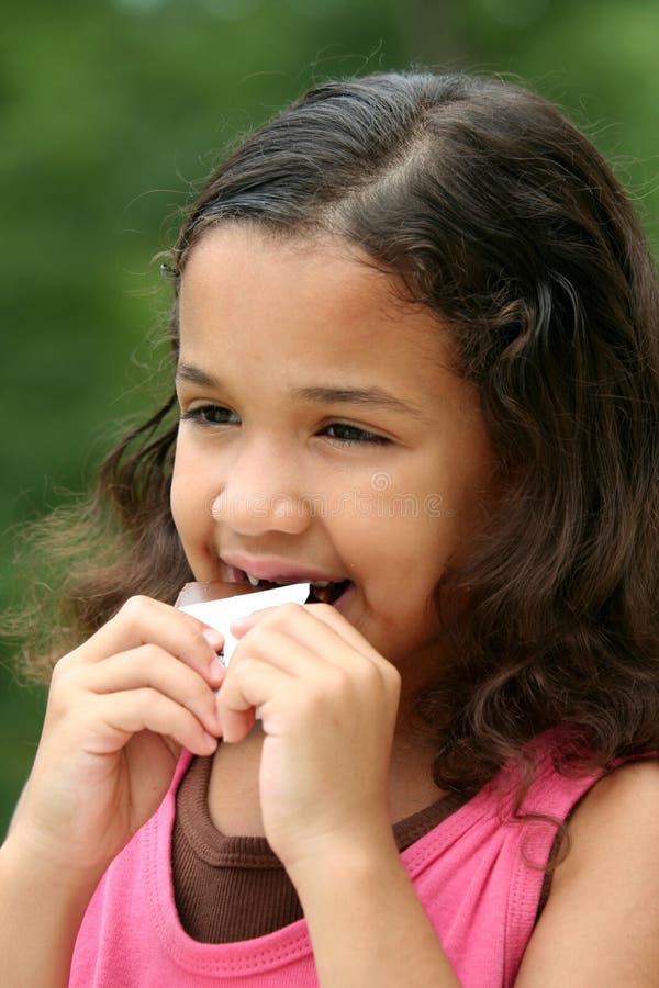 Young Girl Eating Chocolate Stock Photo - Image of eyes, daughter: 1156216