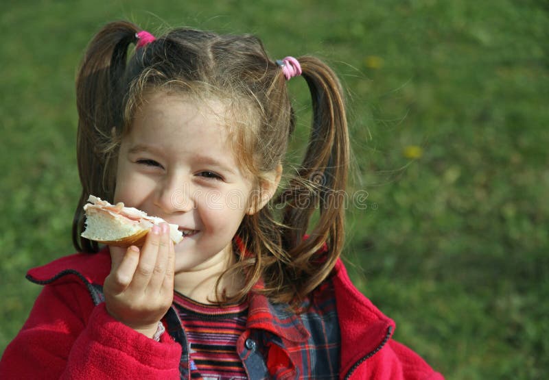 Young Girl while Eating the Sandwich Stock Photo - Image of eating ...