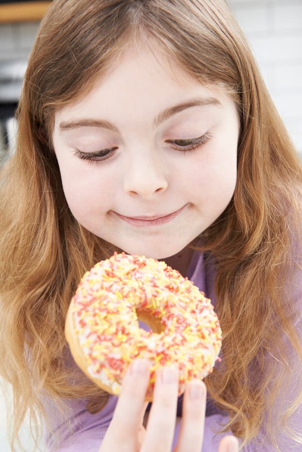 Young Girl Eating Sugary Donut for Snack Stock Image - Image of people ...