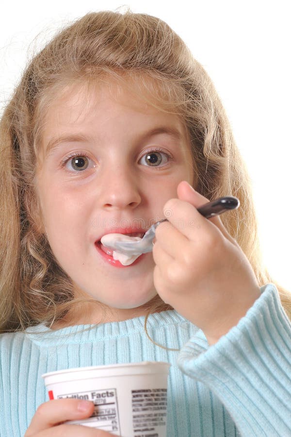 Young Girl Eating Yogurt Vertical Stock Image - Image of looking ...