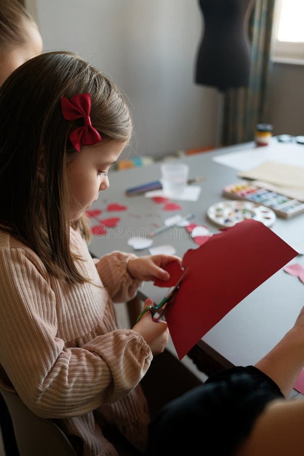Young Girl Engaging in Crafts with Paper and Scissors at Home Stock ...