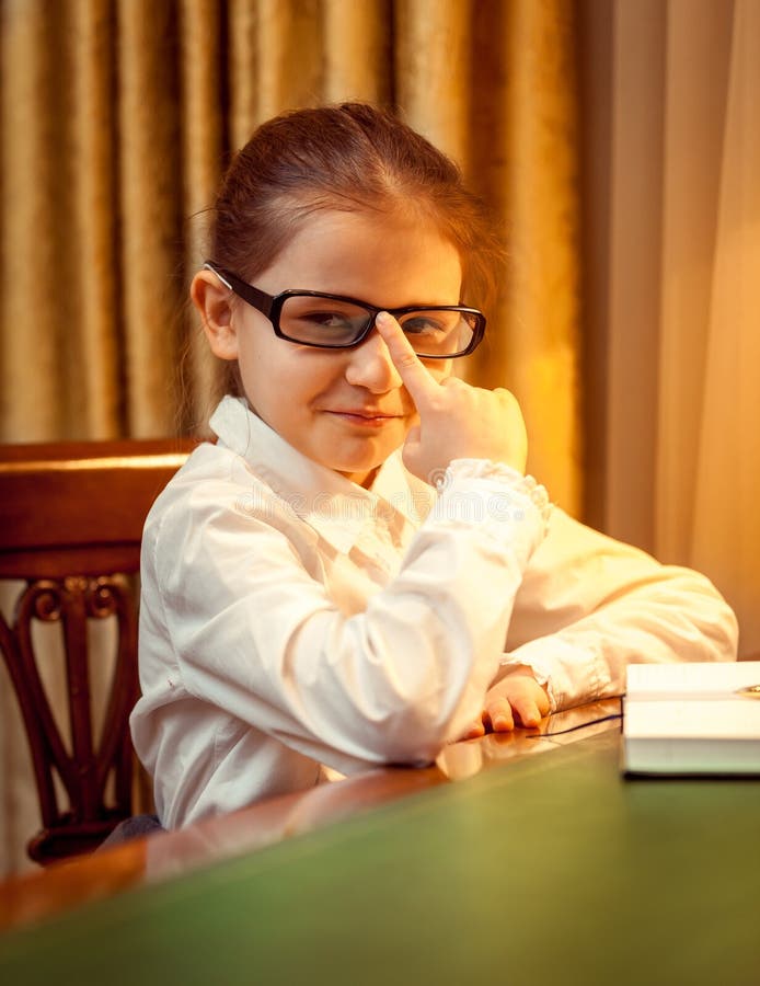 Young Girl In Eyeglasses Sitting Behind Desk Stock Image Image Of