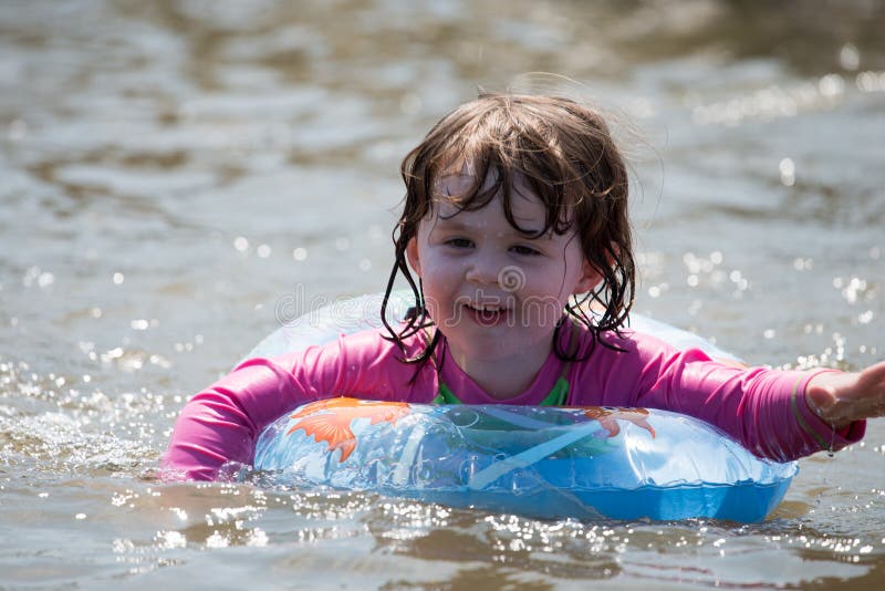 Young Girl Floating in Inner Tubes in a Blissful State Stock Photo ...