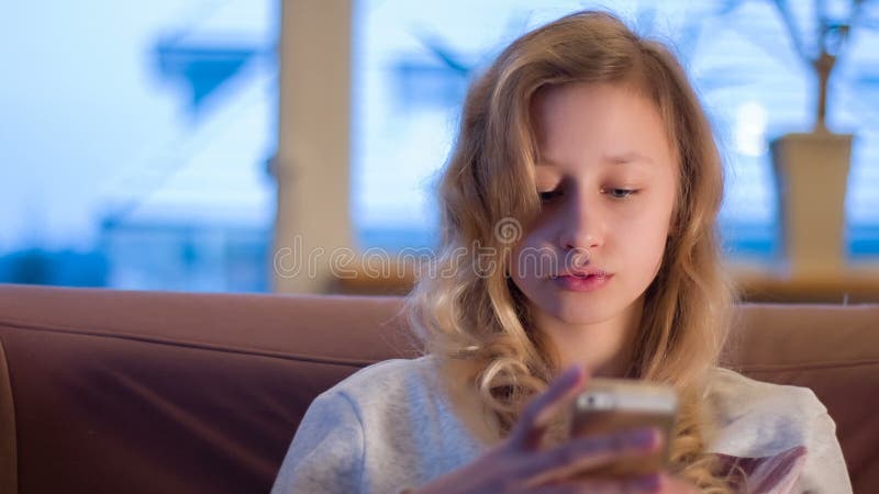 Blonde Young Girl Focus on Smartphone Screen. New Mobile Game App Stock ...