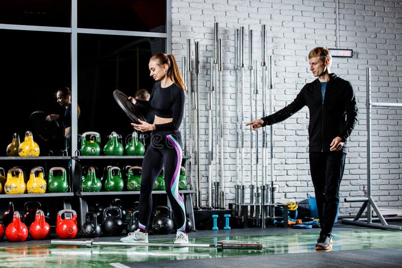 The Girl is Getting Ready for the Exercise with the Trainer Stock Image ...