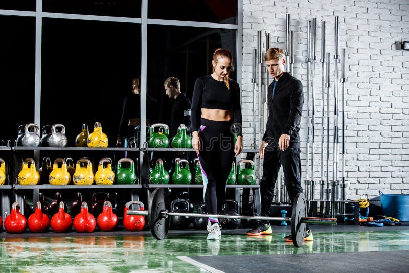 The Girl is Getting Ready for the Exercise with the Trainer Stock Image ...