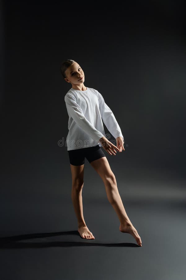 Young Girl Gracefully Dancing in Studio with Dramatic Lighting Stock ...