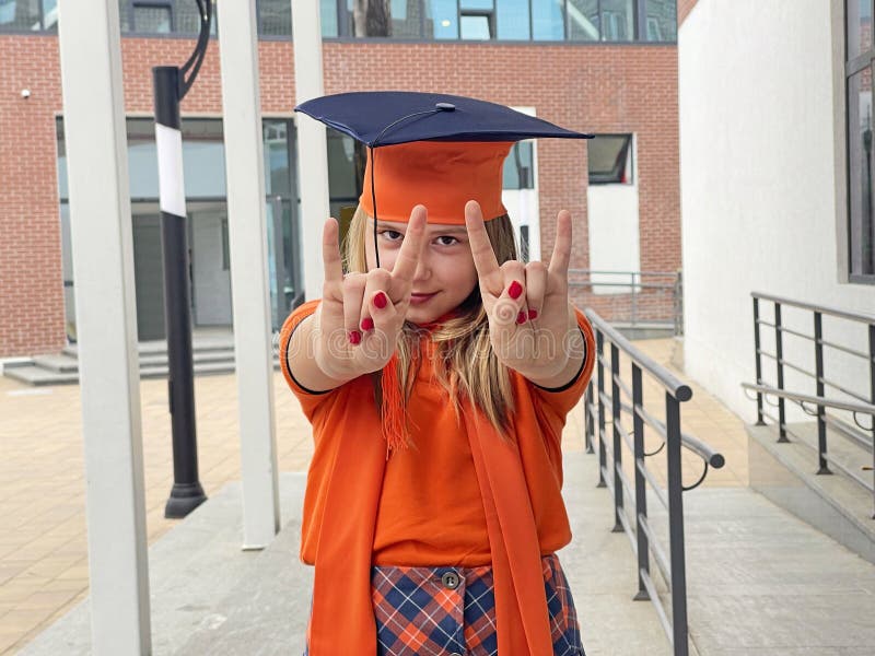A Young Girl in a Graduation Cap Smiling and Looking at Camera ...