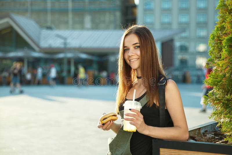 A Young Girl Has Dinner Fast Food in the Town Square Stock Image ...