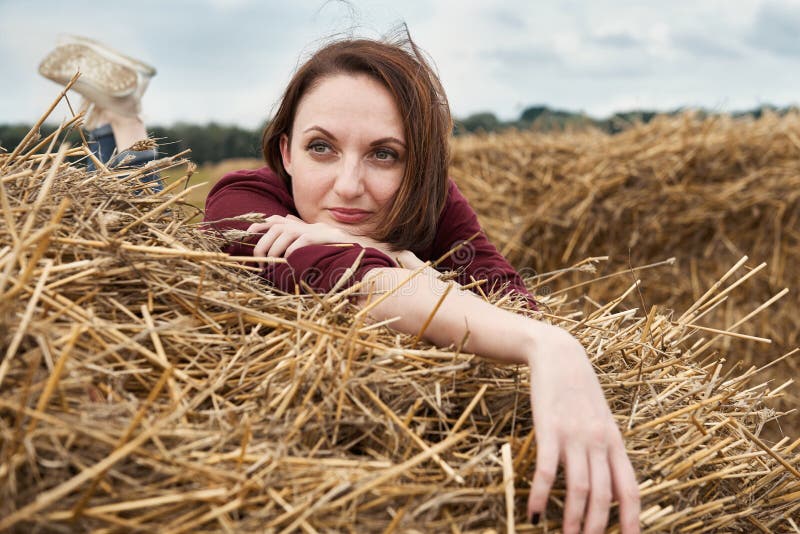 Young Girl Having Fun in the Field, Lying on a Haystack Stock Image ...
