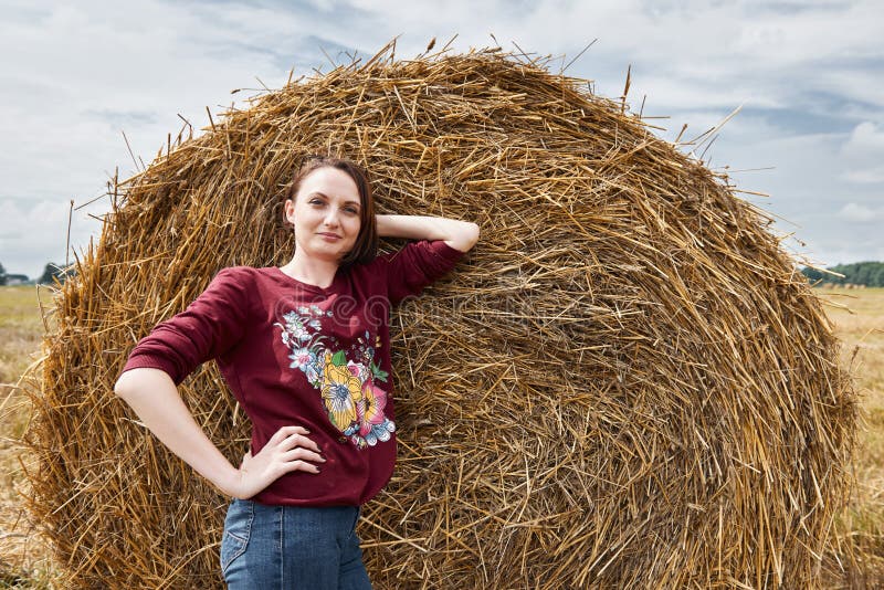 Young Girl Having Fun in the Field, Mowed Hay Wrapped in a Haystack ...