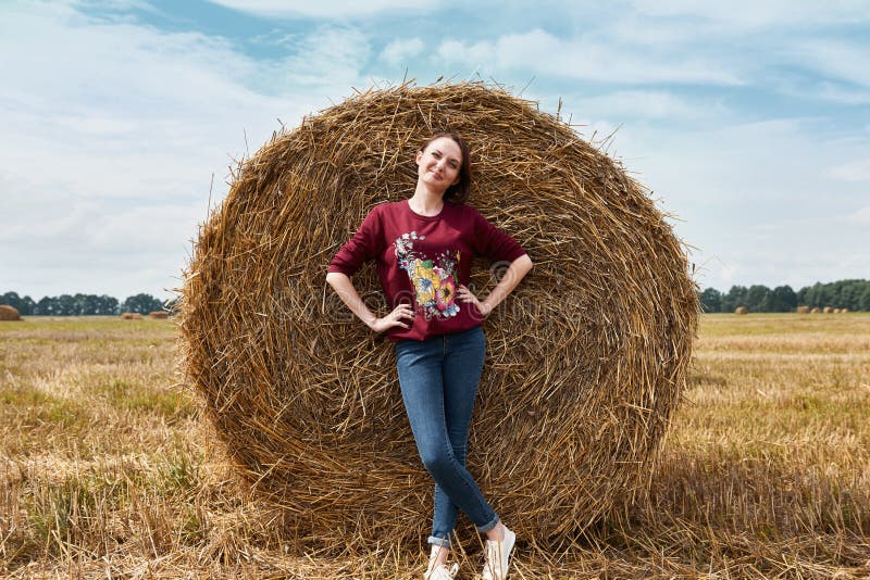 Young Girl Having Fun in the Field, Mowed Hay Wrapped in a Haystack ...