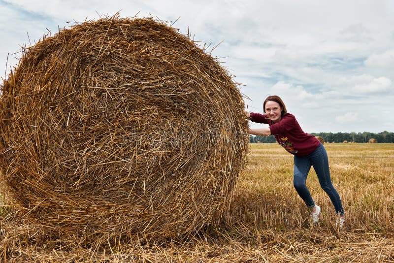 Young Girl Having Fun in the Field, Pushes the Haystack Stock Image ...