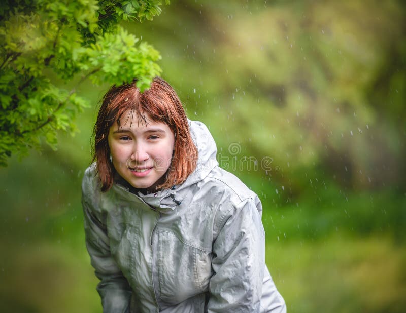 Young Girl Hides from the Rain Under a Bush Stock Photo - Image of ...