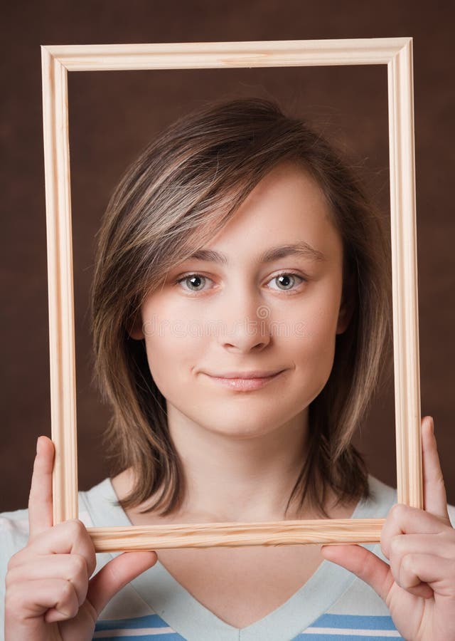 Young girl holding a frame stock image. Image of positive - 7794403