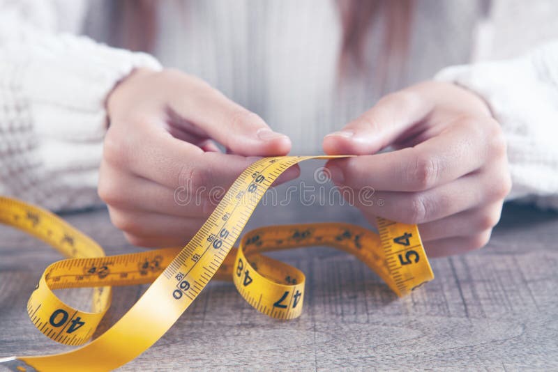 Young Girl Holding a Measuring Tape Stock Image - Image of measurement ...