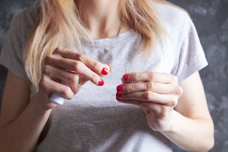 Young Girl Holding a Thread and a Needle Stock Image - Image of holding ...