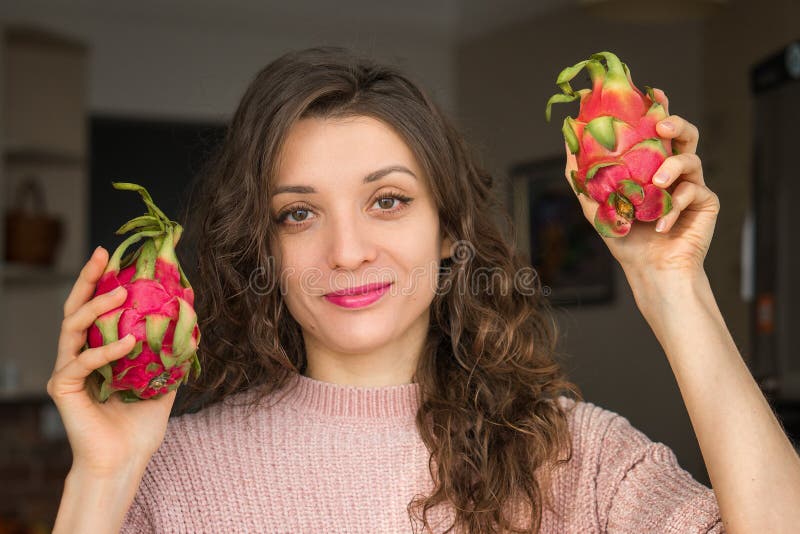 Young Girl Is Holding Two Fresh Ripe Organic Dragon Fruits Or Pitaya