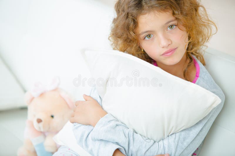 Young girl hugging pillow stock image. Image of guide - 95335811