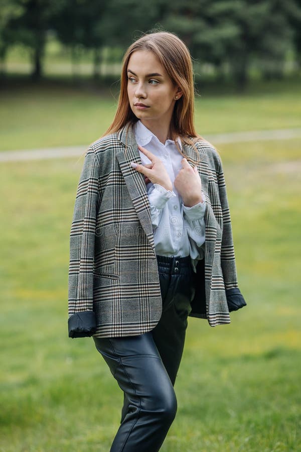 A Young Girl in a Jacket Poses in a Park in the Summer. Stock Photo ...