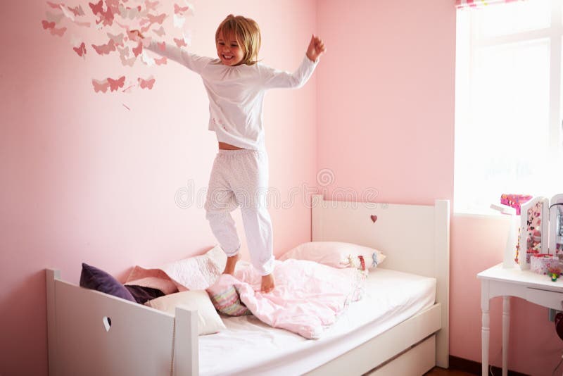 Young Girl Jumping on Her Bed Stock Image - Image of bedding, leap ...