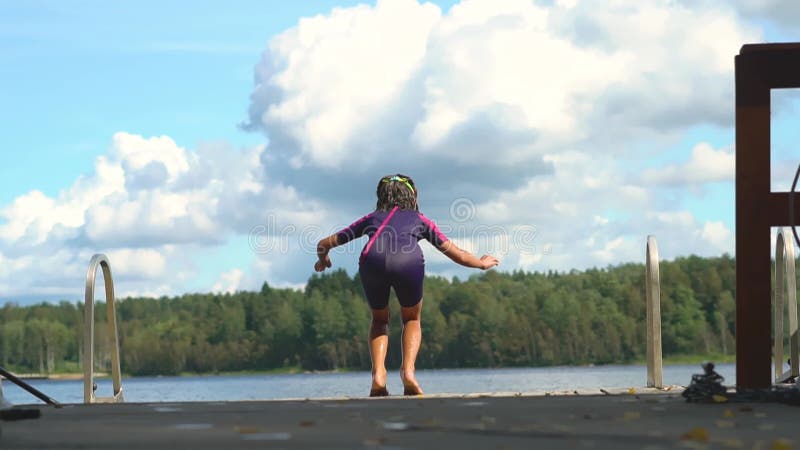 Young Girl Jumping into Water Stock Video - Video of pier, body: 183771657