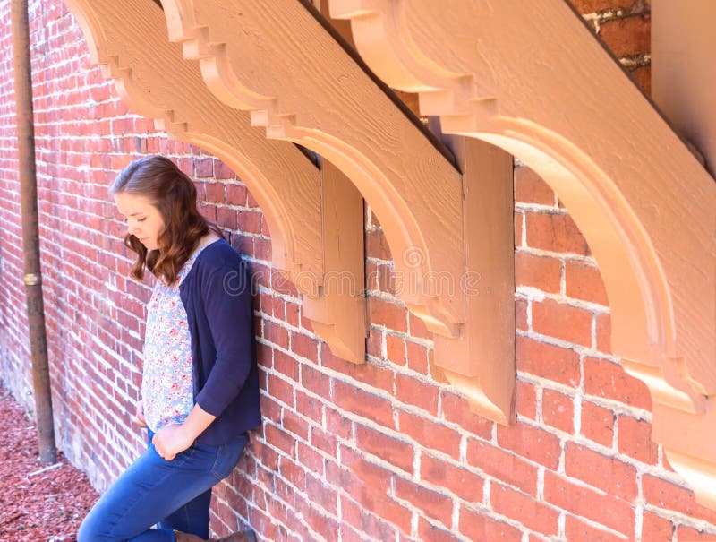 Girl Leaning Against Red Brick Wall Stock Image Image Of Outside