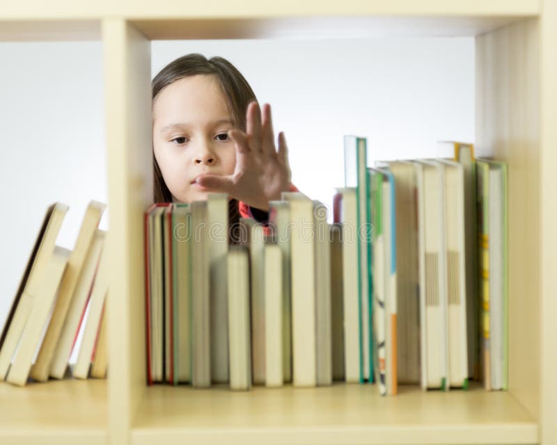 Young Girl Looking at Books on Bookshelf Stock Photo - Image of shelf ...