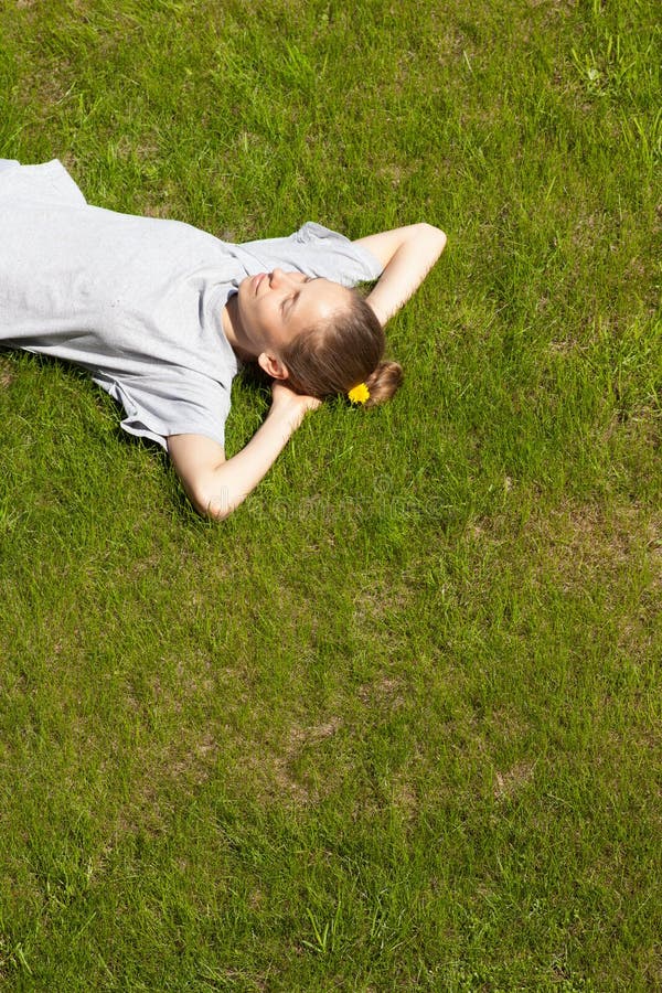 Young Girl Lying on the Grass Stock Image - Image of young, park: 40934143