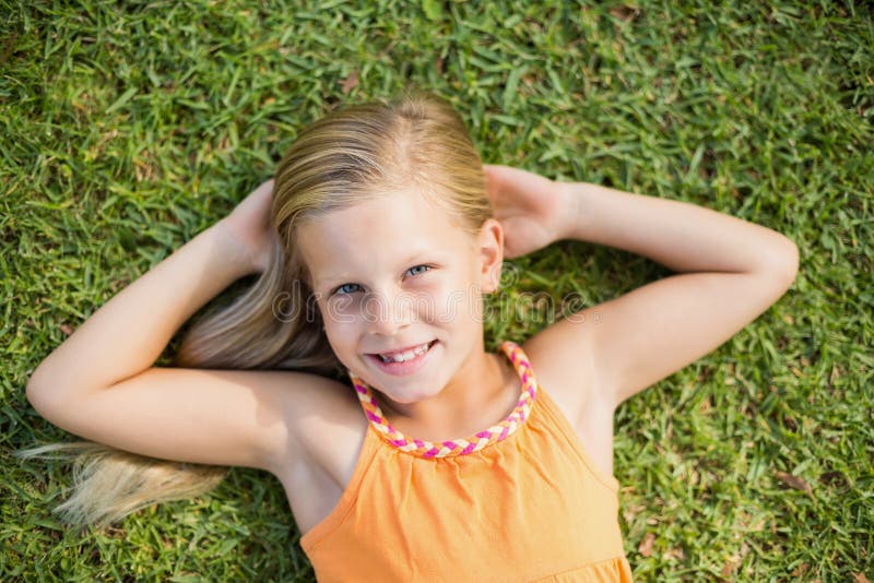 Young girl lying on grass stock image. Image of looking - 77902369